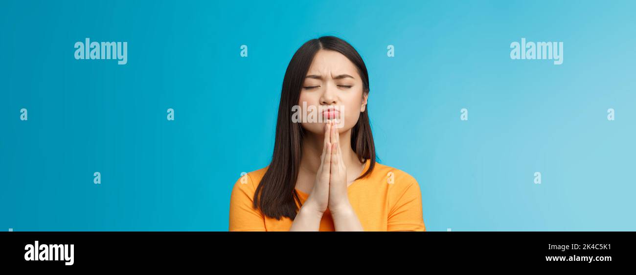 Determined motivated cute asian female praying dream come true, slap ...