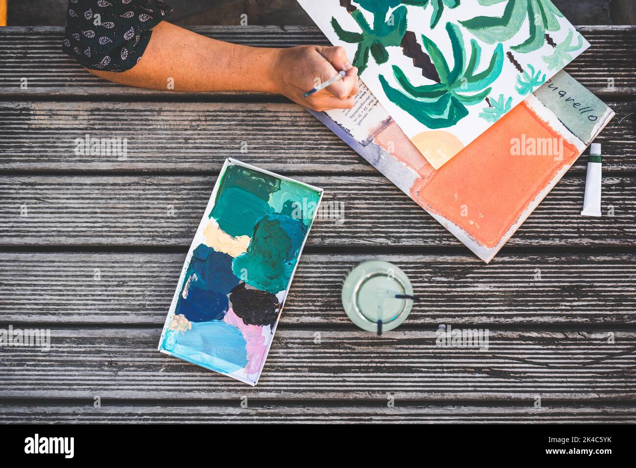 Hand and arm of a female painter painting a canvas Stock Photo - Alamy