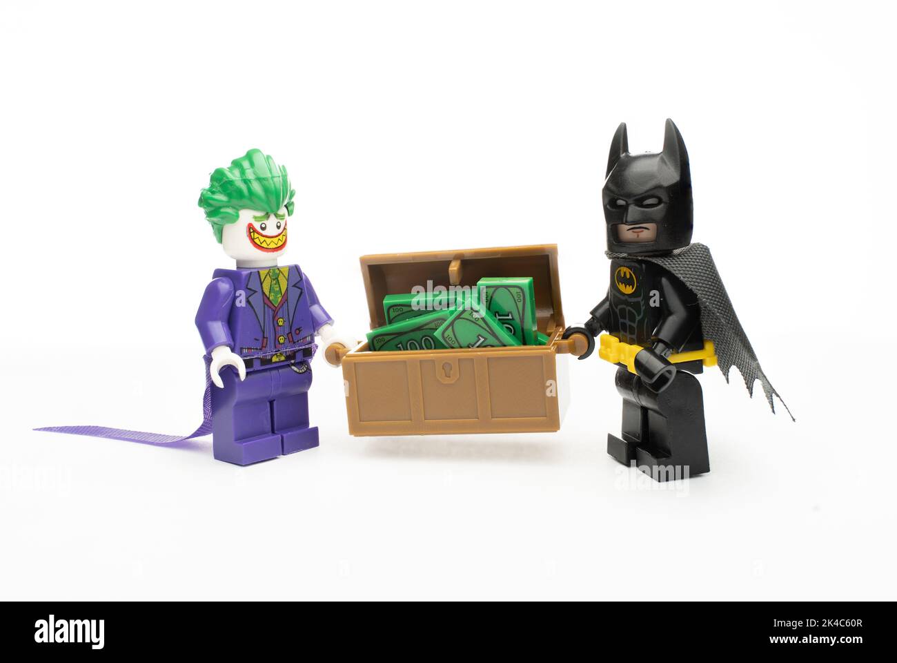 A Batman and the joker carrying a case full of money stock photography ...