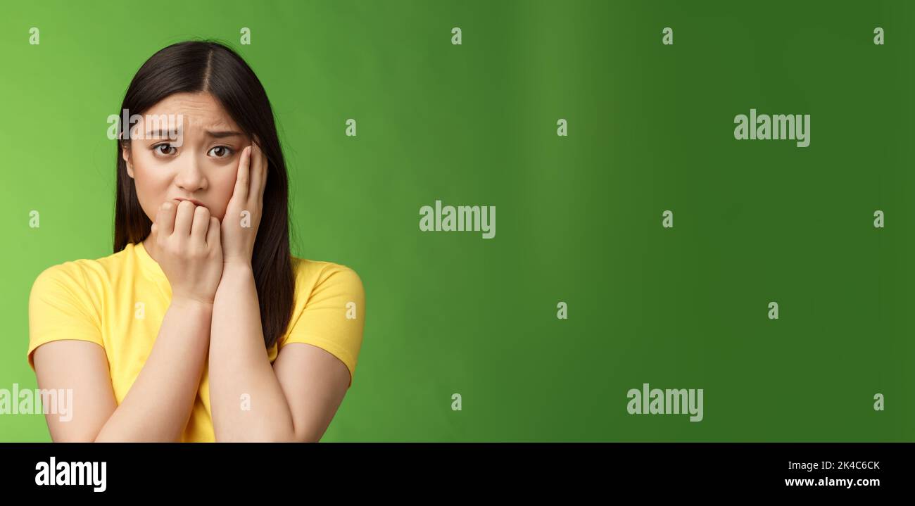 Innocent insecure timid asian scared girl panicking, standing afraid victim terrified, touch ...