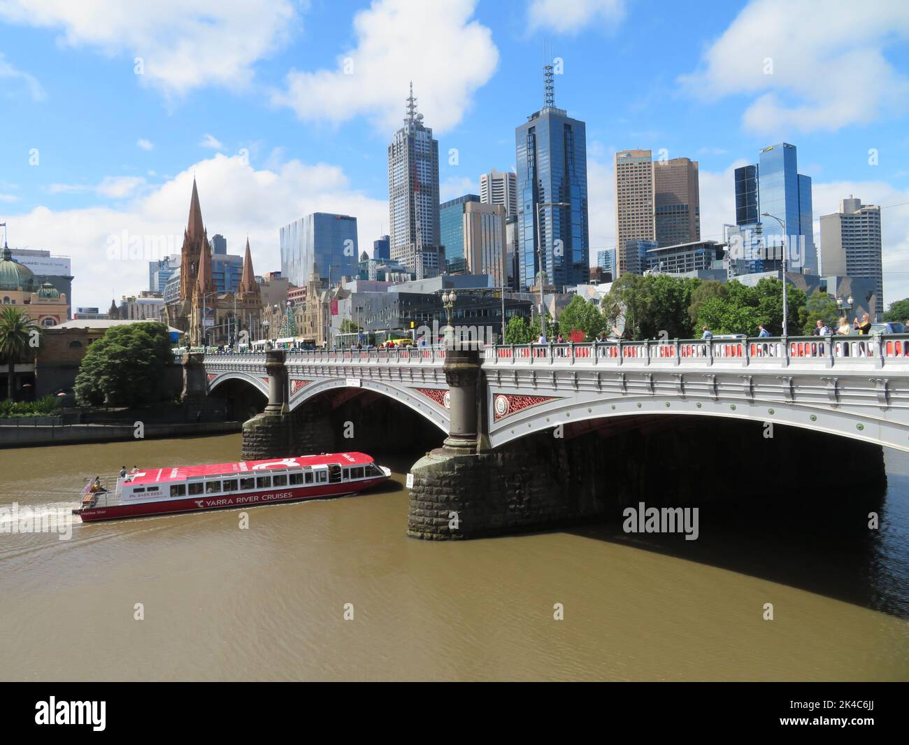 The Melbourne cityscape with modern buildings and a boat under the ...