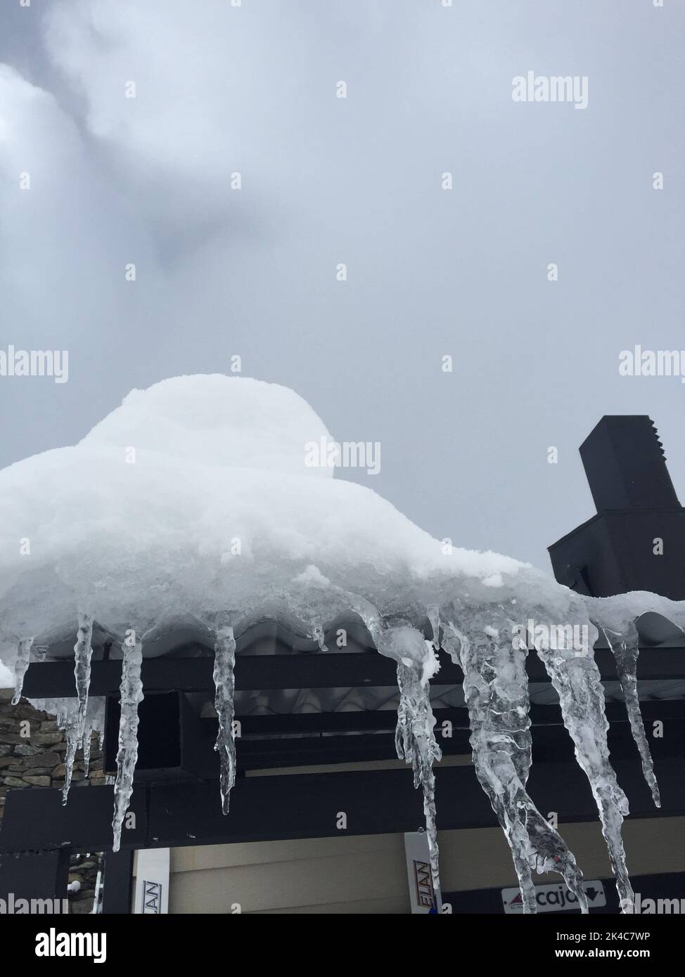 ice hanging from the roof of a house after rain in winter Stock Photo ...