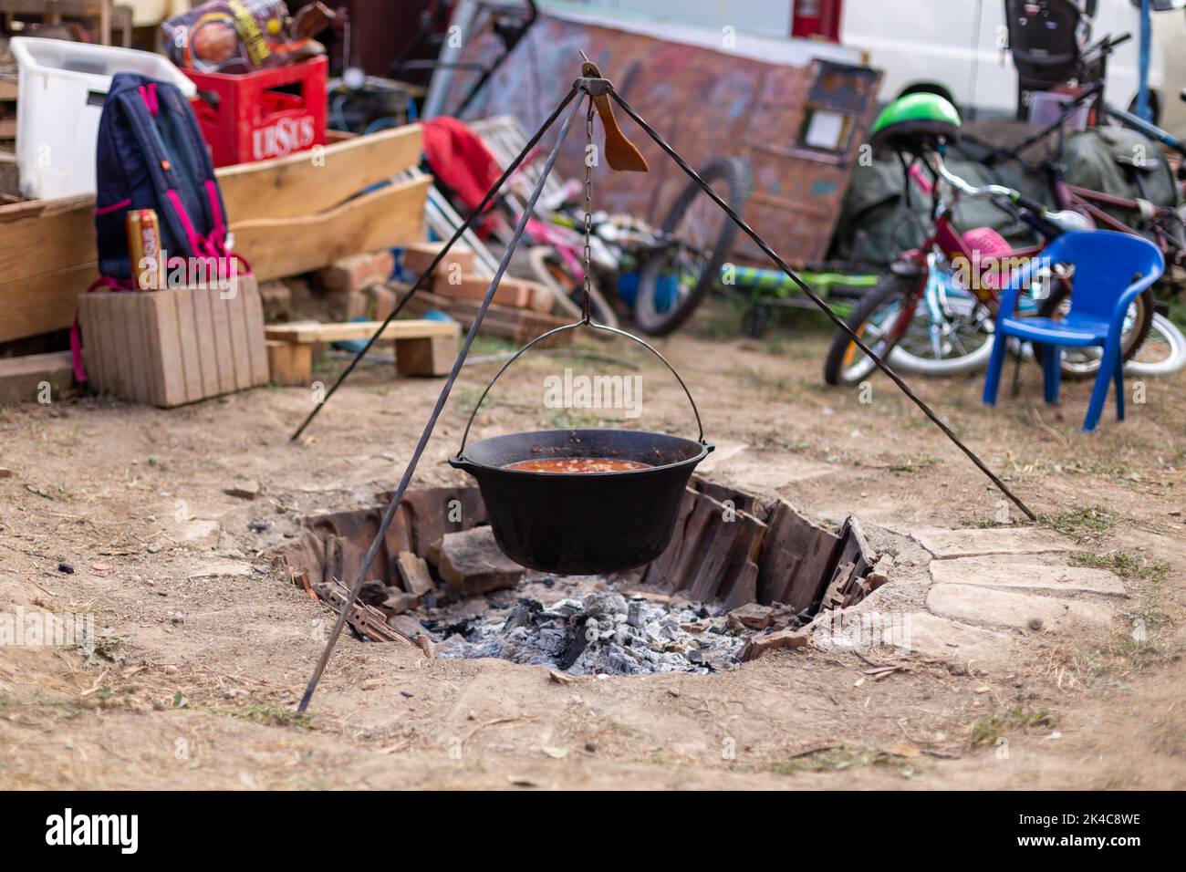 A beautiful shot of soup in a cast iron boiler on burning campfire ...
