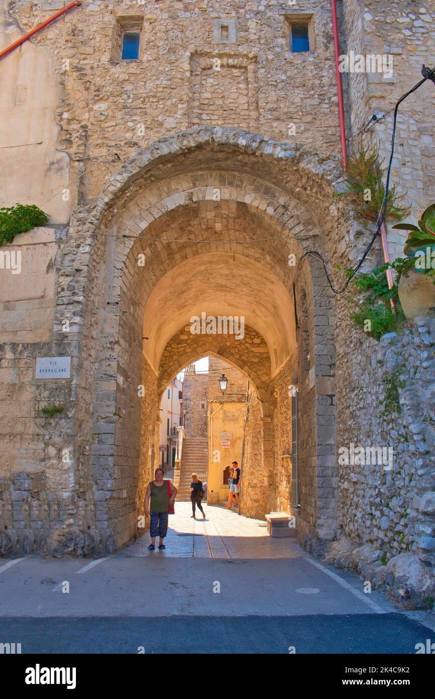 A vertical shot of an ancient arched gate in the historic town of ...
