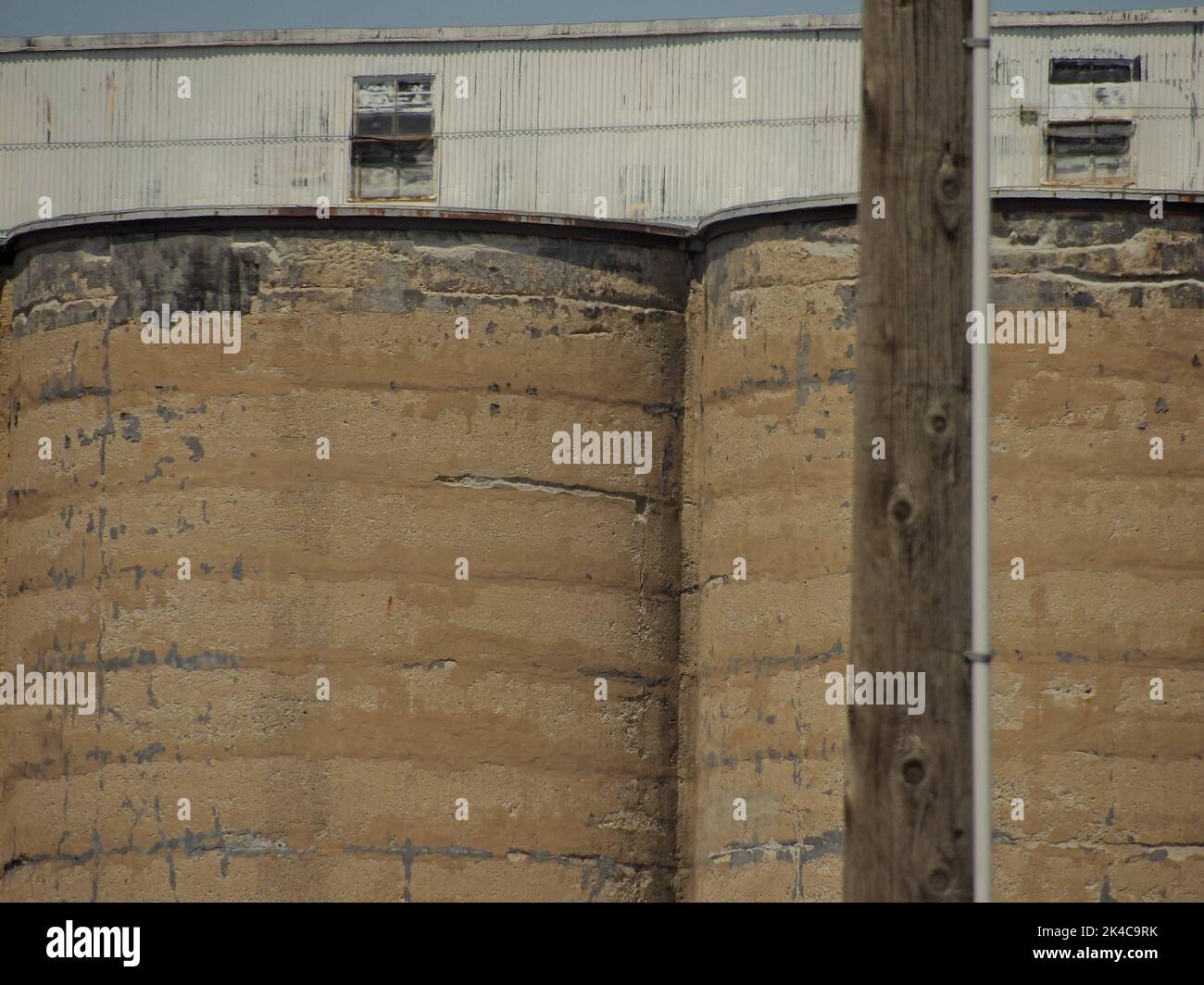 Old concrete containers of cement factory Stock Photo - Alamy