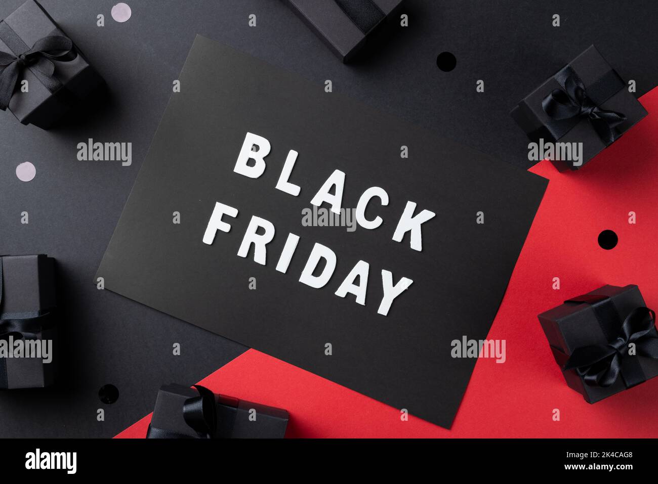 Composition of presents and black friday text on gray and pink ...