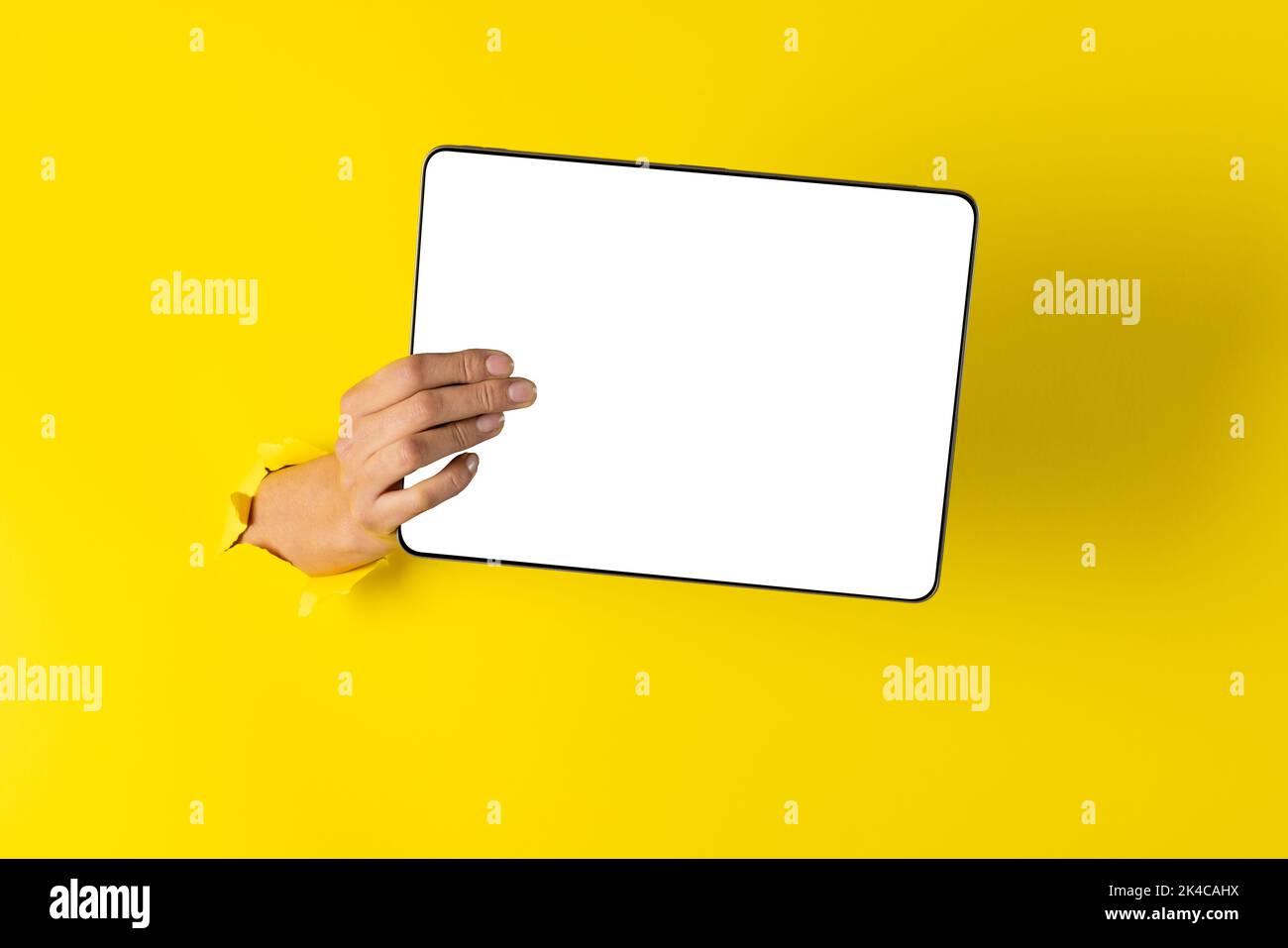 Composition of hand holding board with copy space on yellow background ...