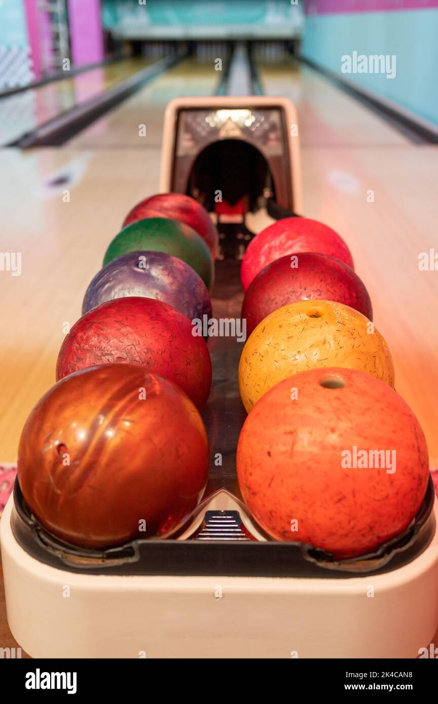 A vertical shot of colorful bowling balls Stock Photo - Alamy