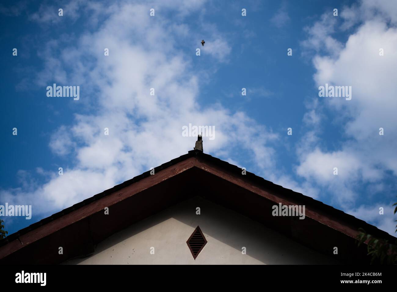 A closeup of a house roof against a blue sky background Stock Photo - Alamy