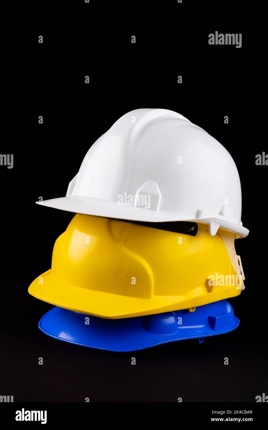 Vertical image of stack of helmets lying on black surface Stock Photo ...