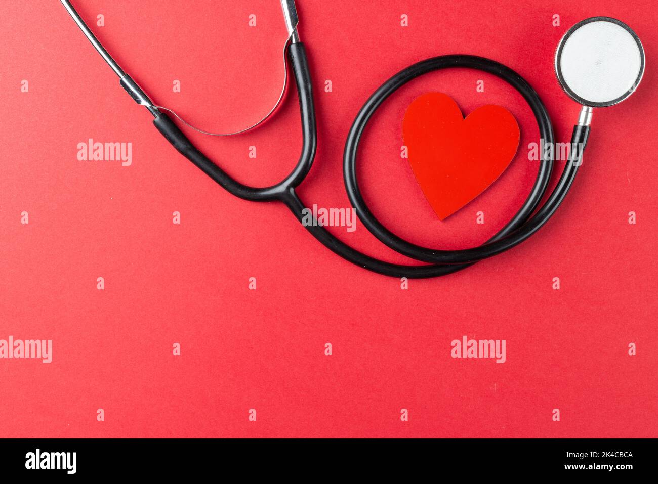 Image of red heart and stethoscope on red surface Stock Photo - Alamy