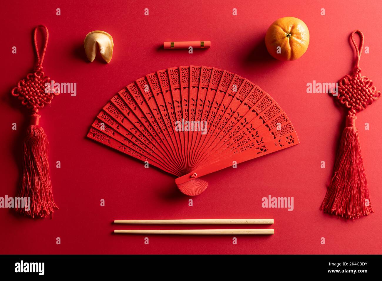 Composition of traditional chinese fan and decorations on red ...