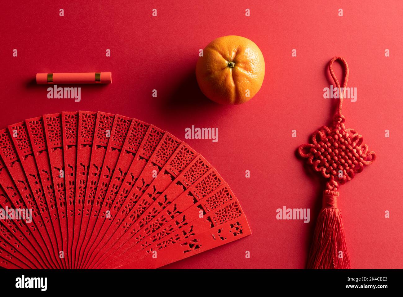 Composition of traditional chinese fan and decorations on red ...