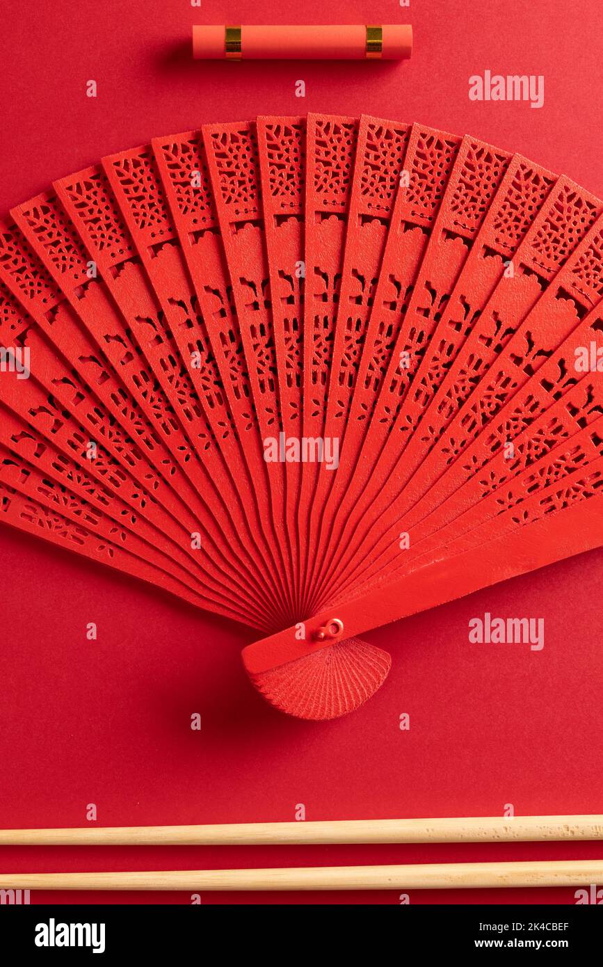 Composition of traditional chinese fan and decorations on red ...