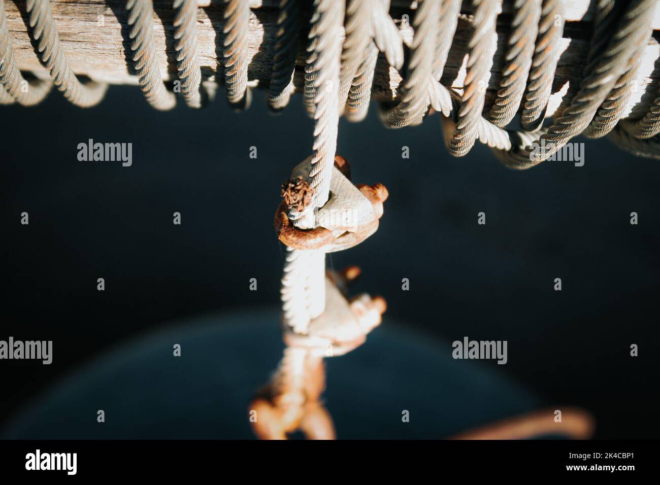 A closeup shot of roap of an old well with a bucket Stock Photo - Alamy