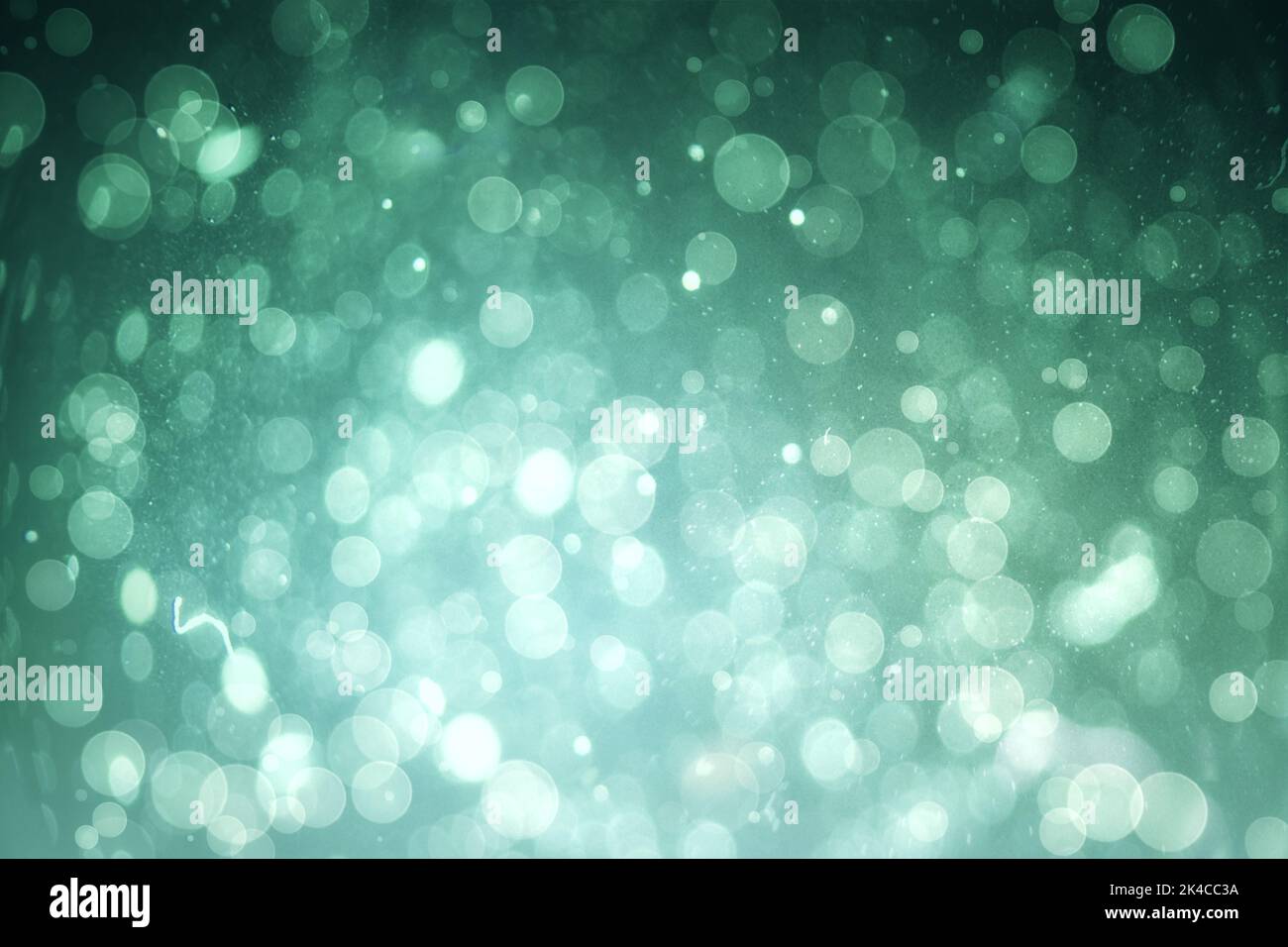 Abstract illustration of bokeh spots of light against green background ...