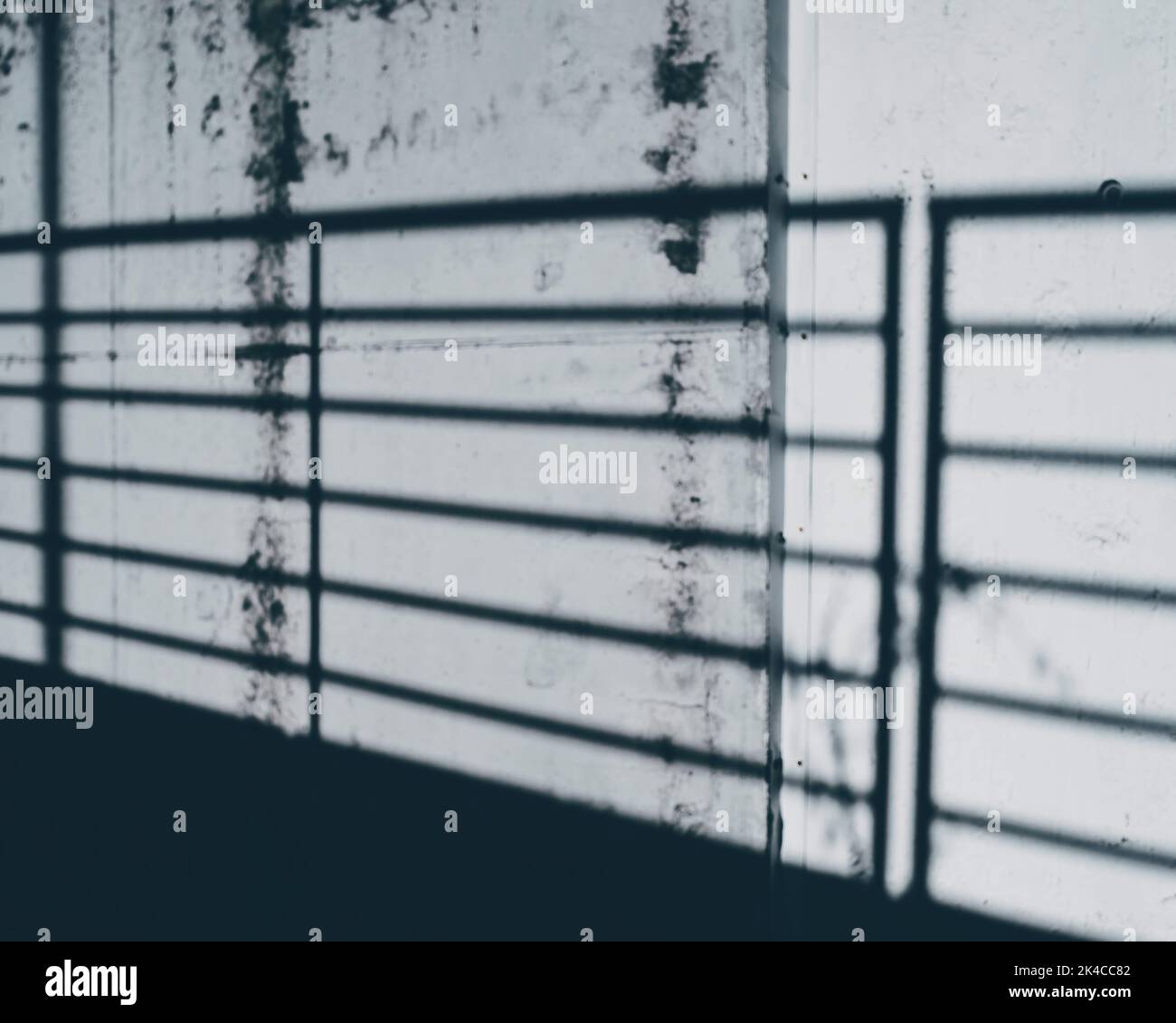 The shadow of metal fence on white wall with light Stock Photo - Alamy