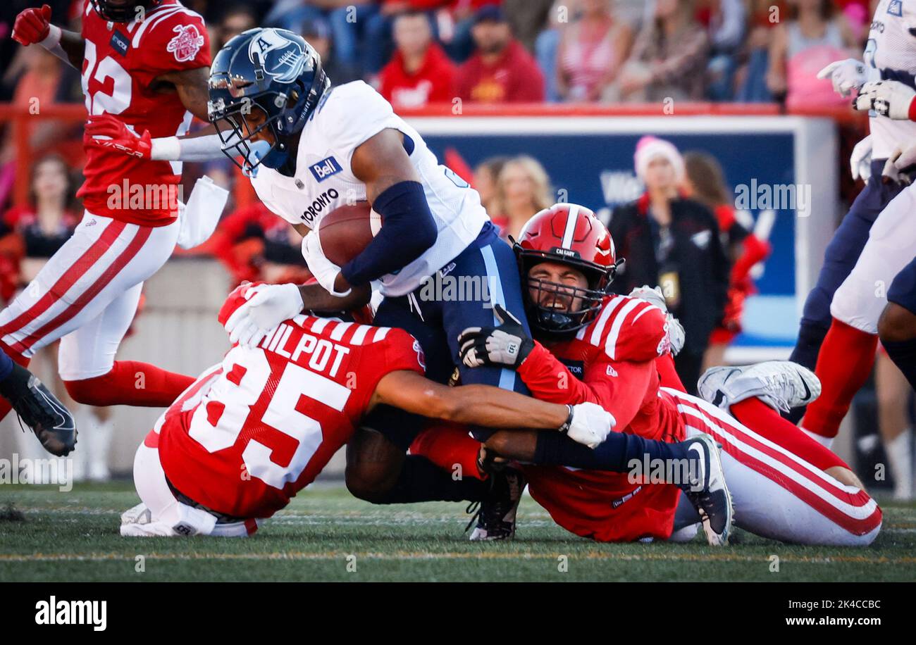 Toronto Argonauts defensive back Maurice Carnell, centre, is tackled by ...