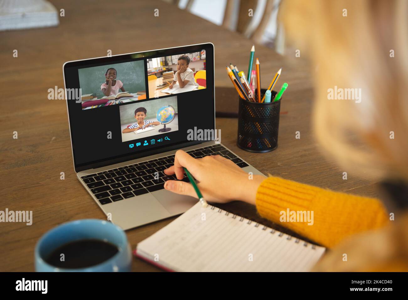 Caucasian woman using laptop for video call, with smiling diverse ...