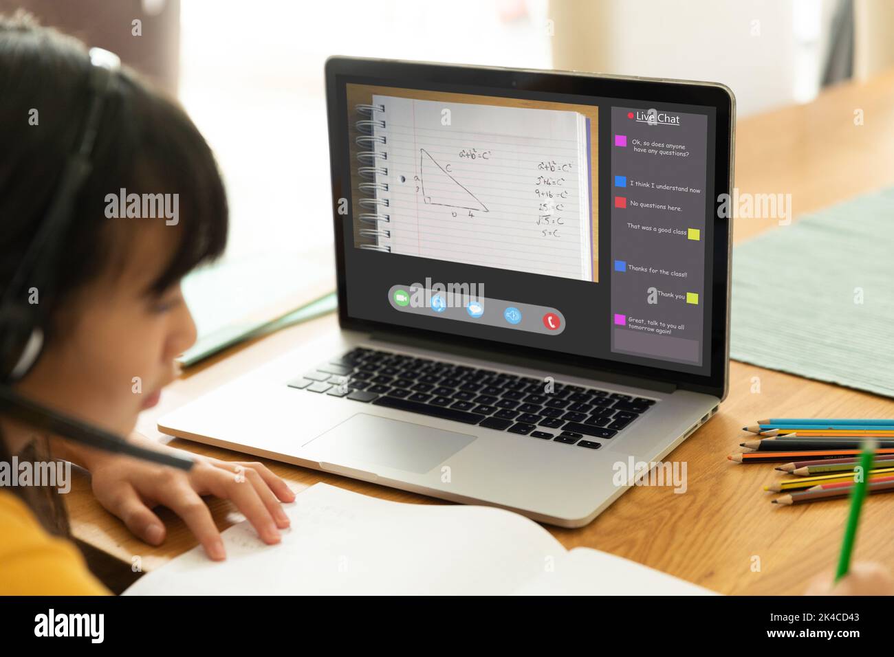 Asian girl using laptop for video call, with class on screen ...