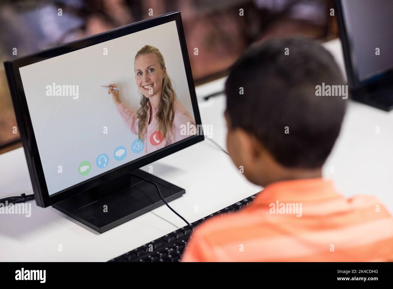 Male student having a video call with female teacher on computer at ...