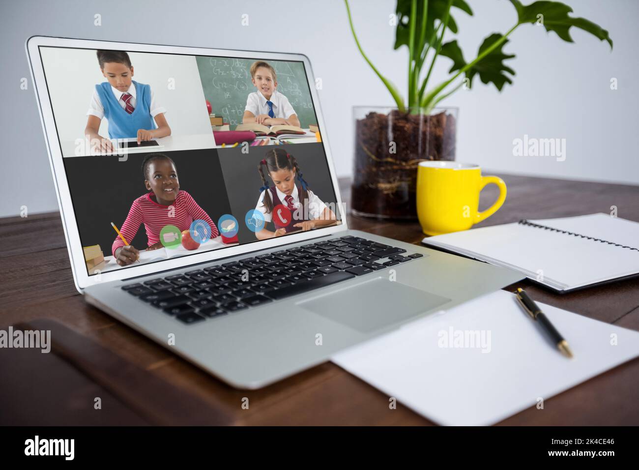 Webcam view of multiple students on video call on laptop on wooden ...