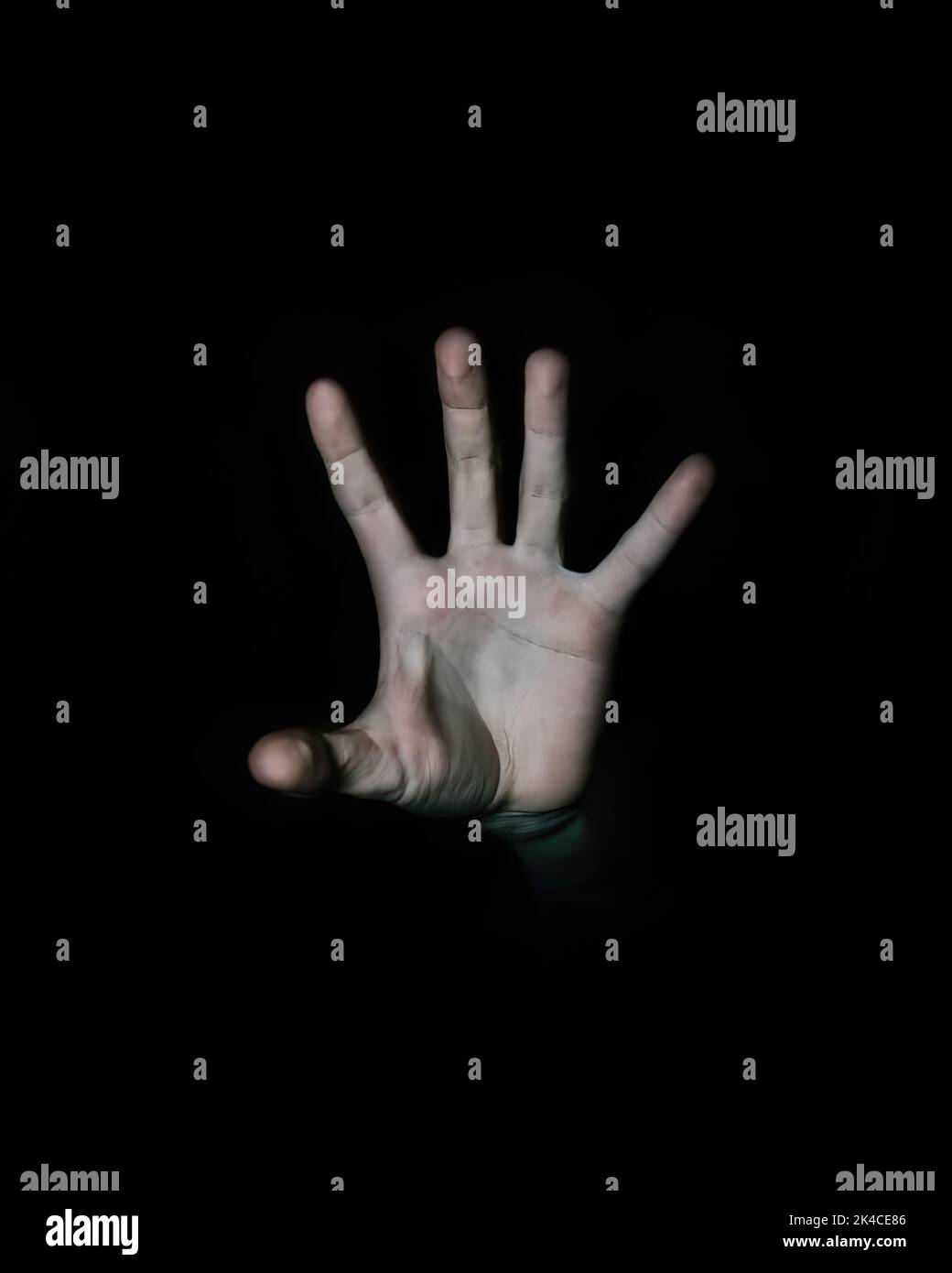 A vertical closeup of a hand in the darkness Stock Photo - Alamy