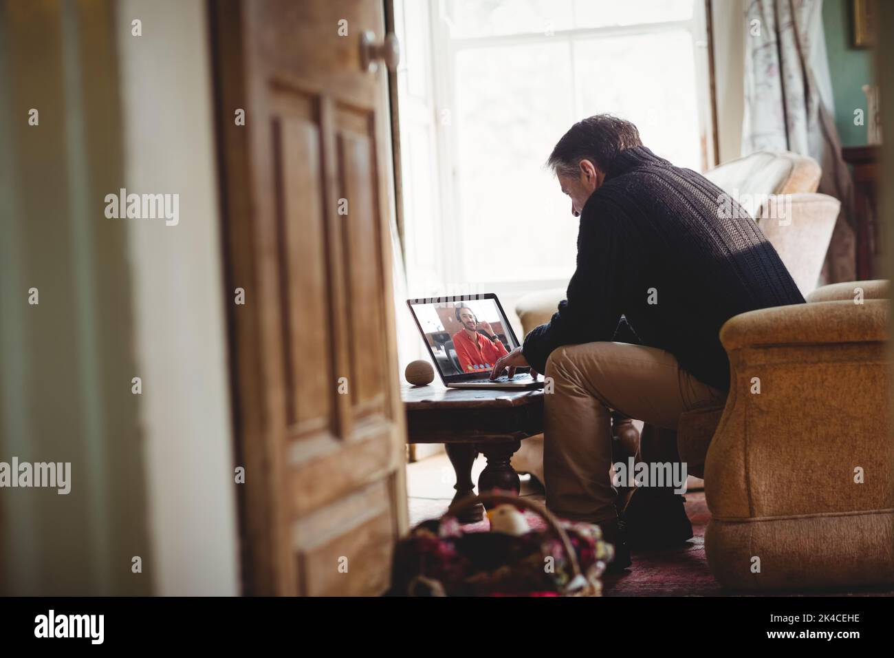 Senior caucasian man using laptop and having video call. staying at ...