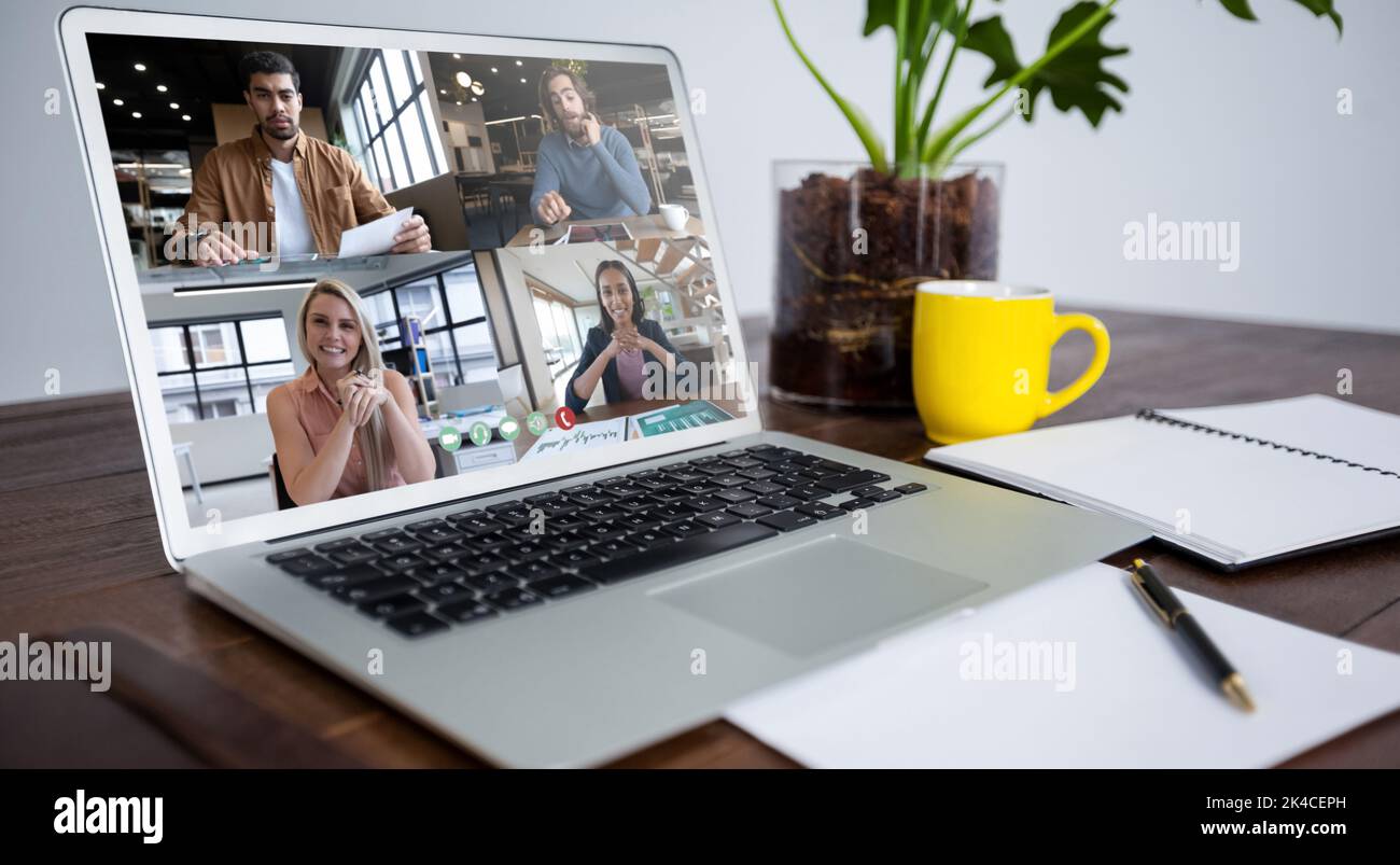 Group of diverse coworkers having video call on screen of laptop on ...