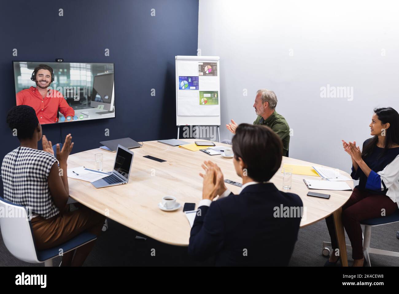 Diverse group of business colleagues having video call with coworker on ...
