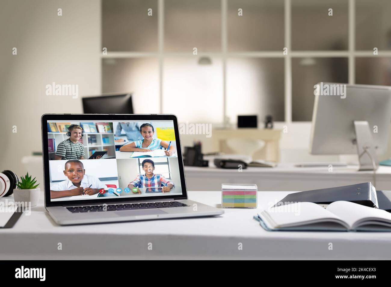 Diverse pupils having online lesson on screen of laptop on desk. at ...