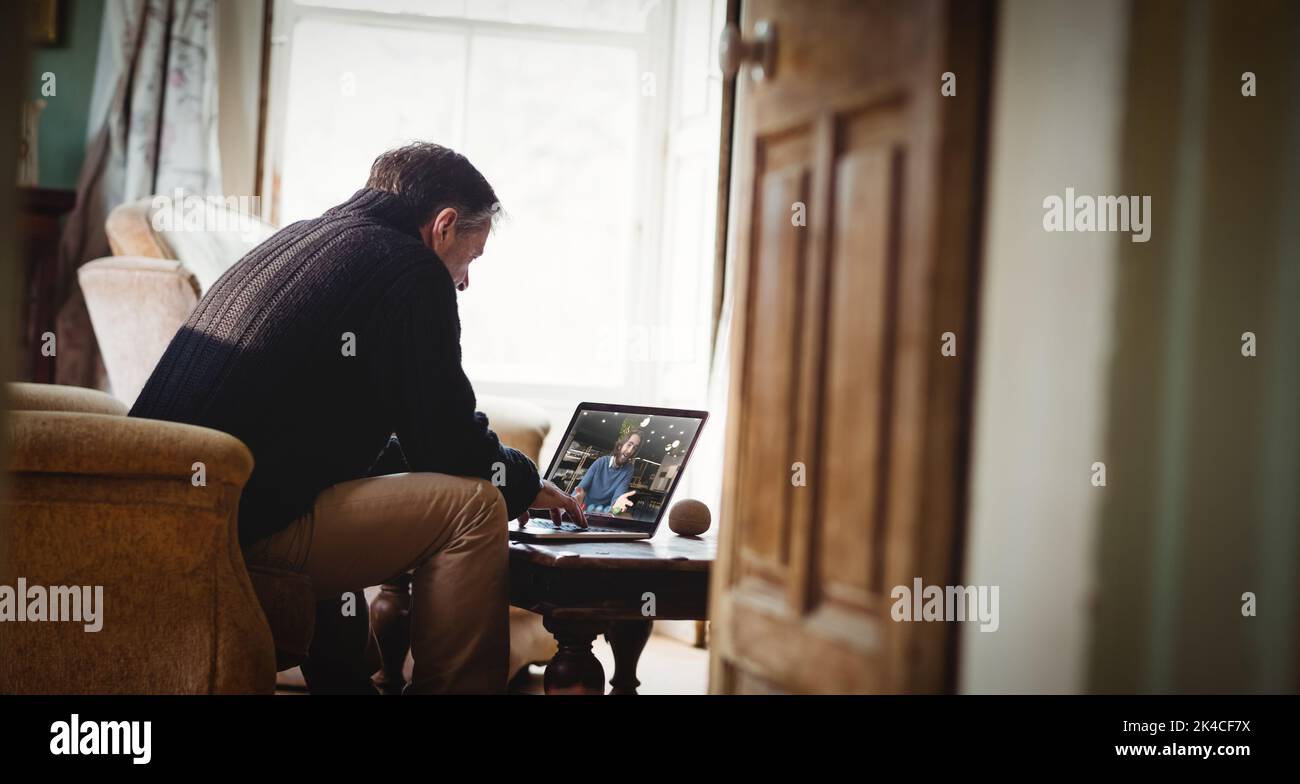 Senior caucasian man using laptop at home having video call with ...