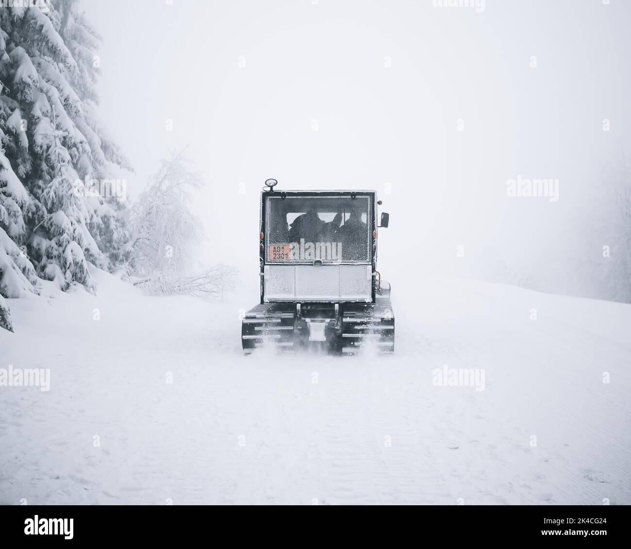 A compact modern snowcat moveing on snow Stock Photo - Alamy