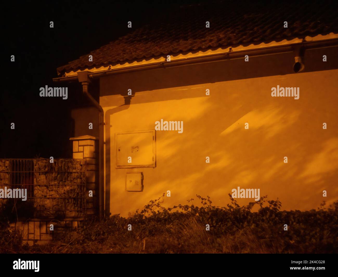 The house wall illuminated by street lamps at night Stock Photo - Alamy