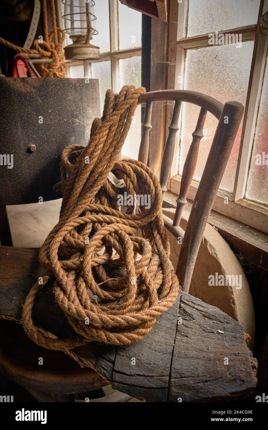 A vertical of an old rope hung over a broken wooden chair Stock Photo ...
