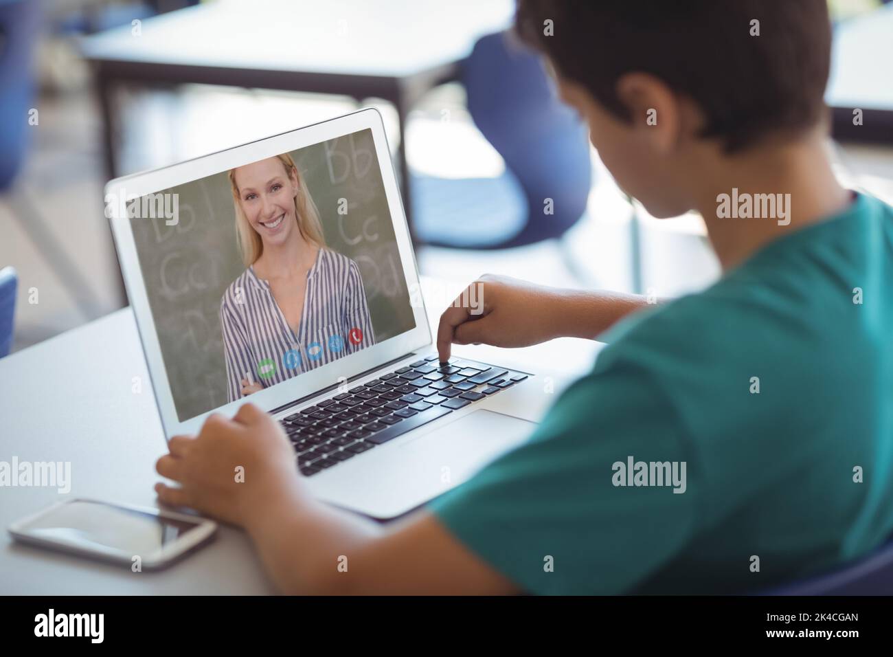 Male caucasian student having a video call with female teacher on ...