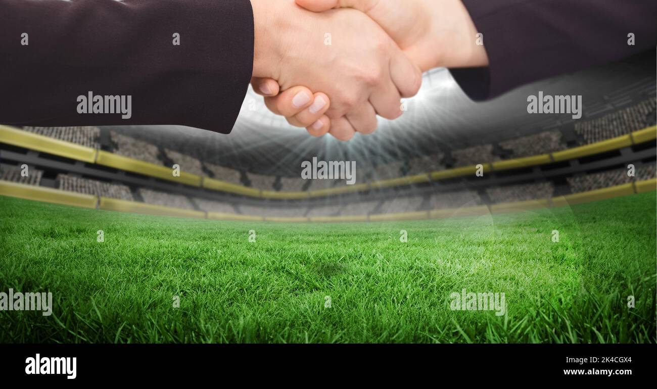 Composition of businessman and businesswoman shaking hands over sports ...