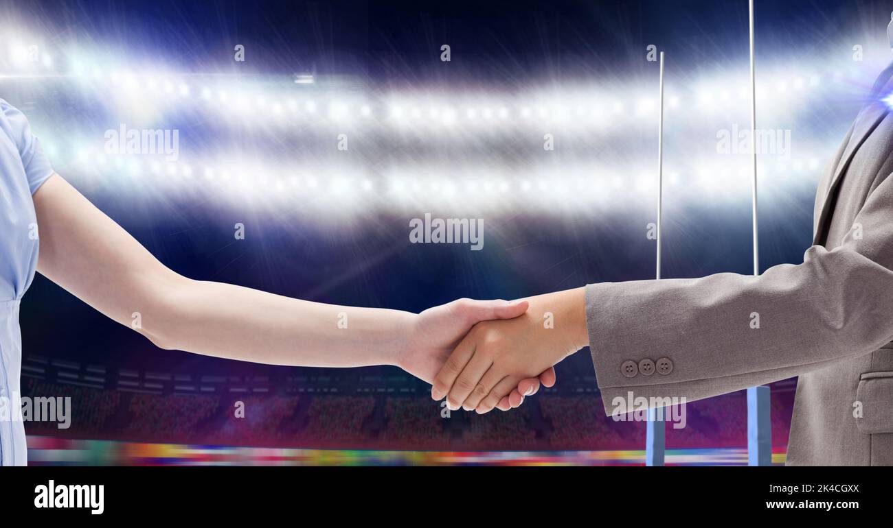 Composition of businessman and businesswoman shaking hands over sports ...