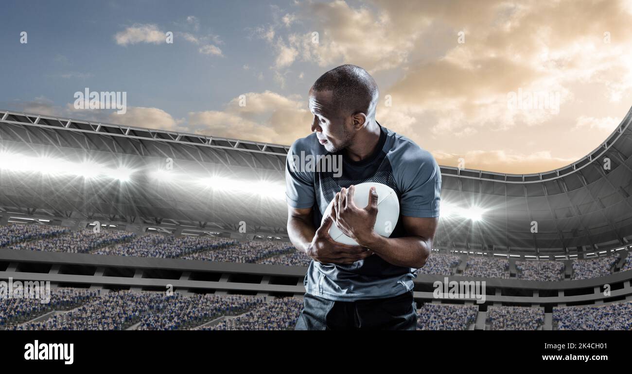 Composition of male rugby player holding rugby ball over sports stadium ...
