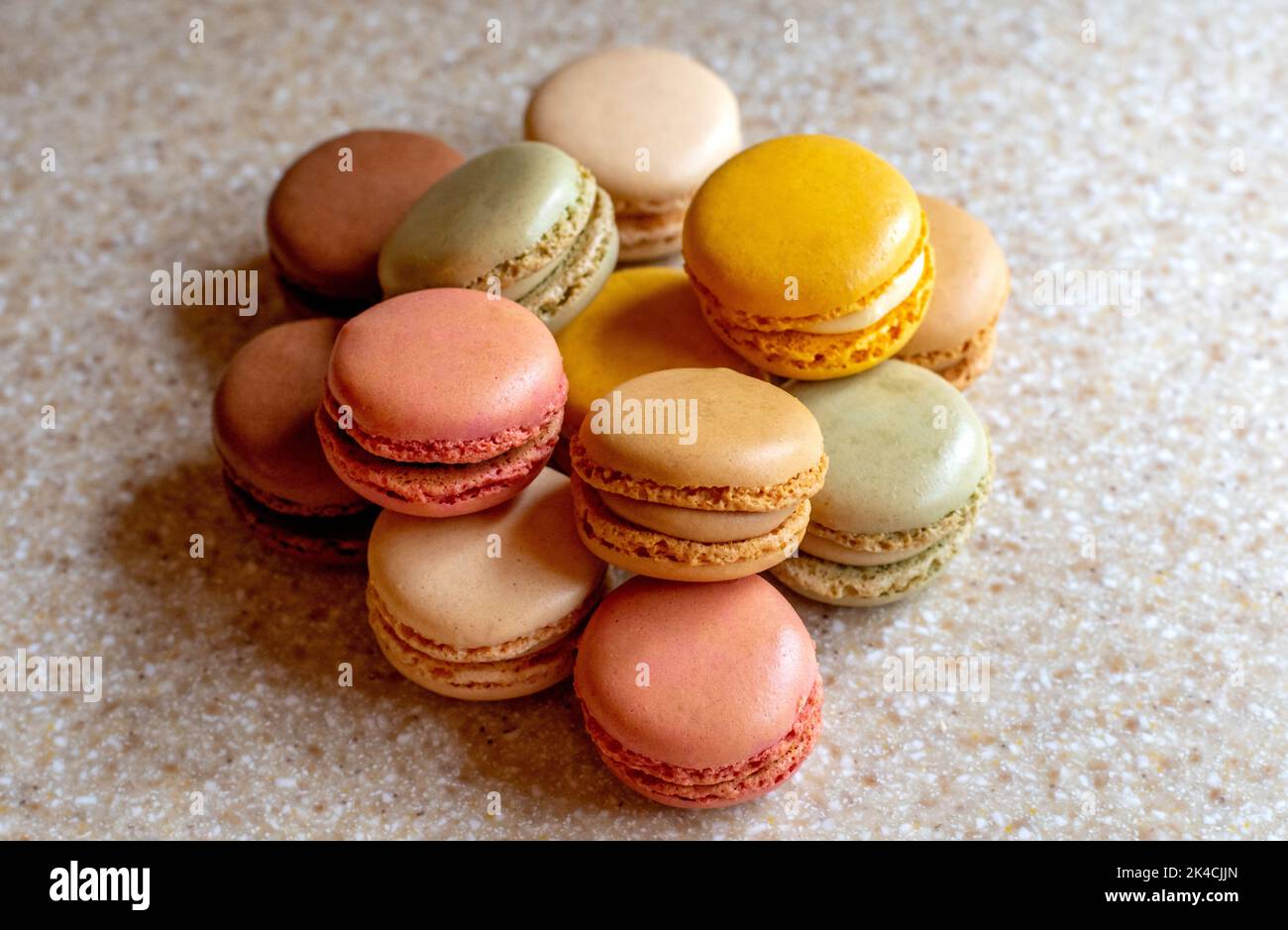 Still life of crispy meringue macarons filled with luscious creamy ...
