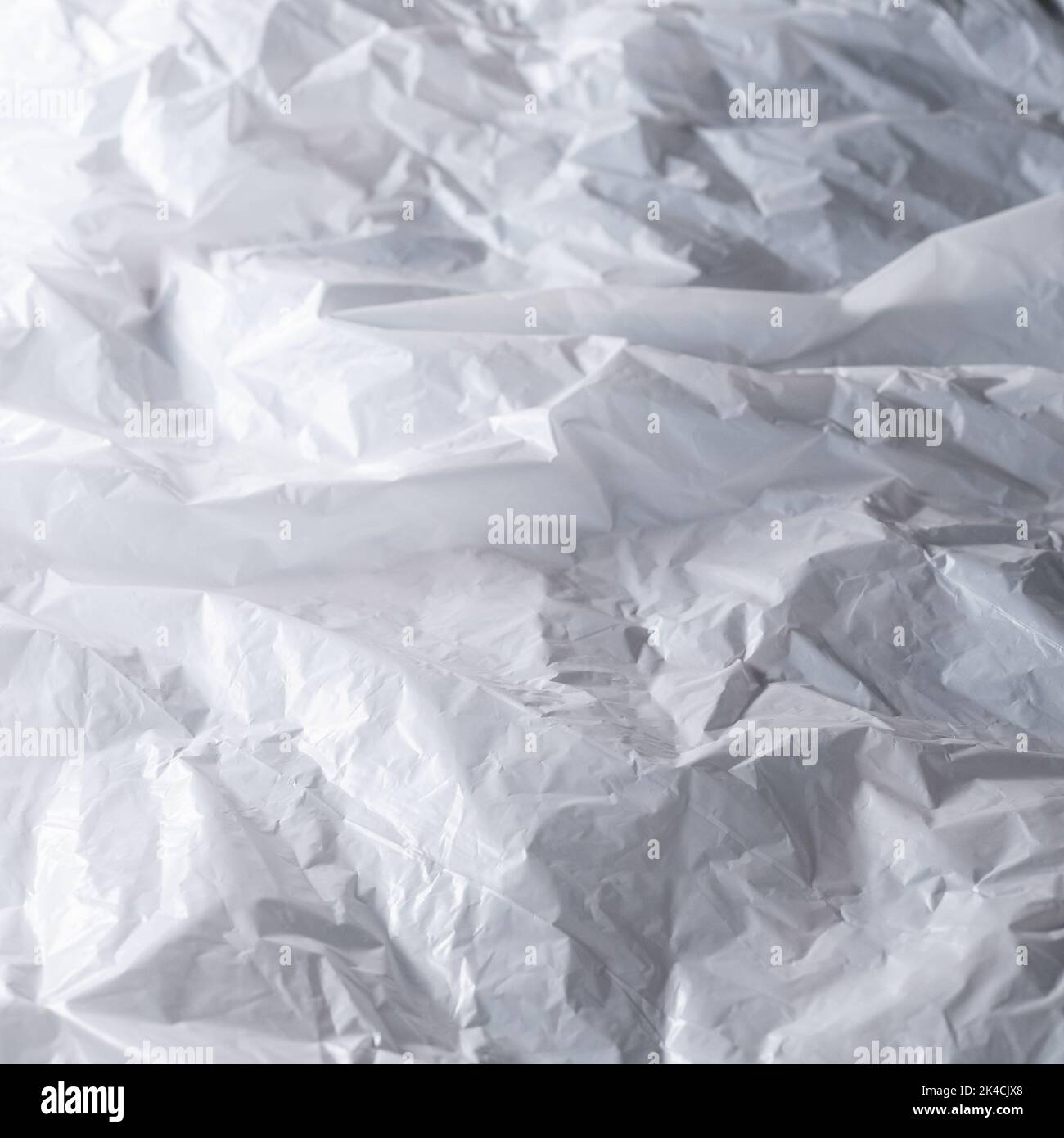 Reflecting light and shadow on creases and folds in scrunched white ...