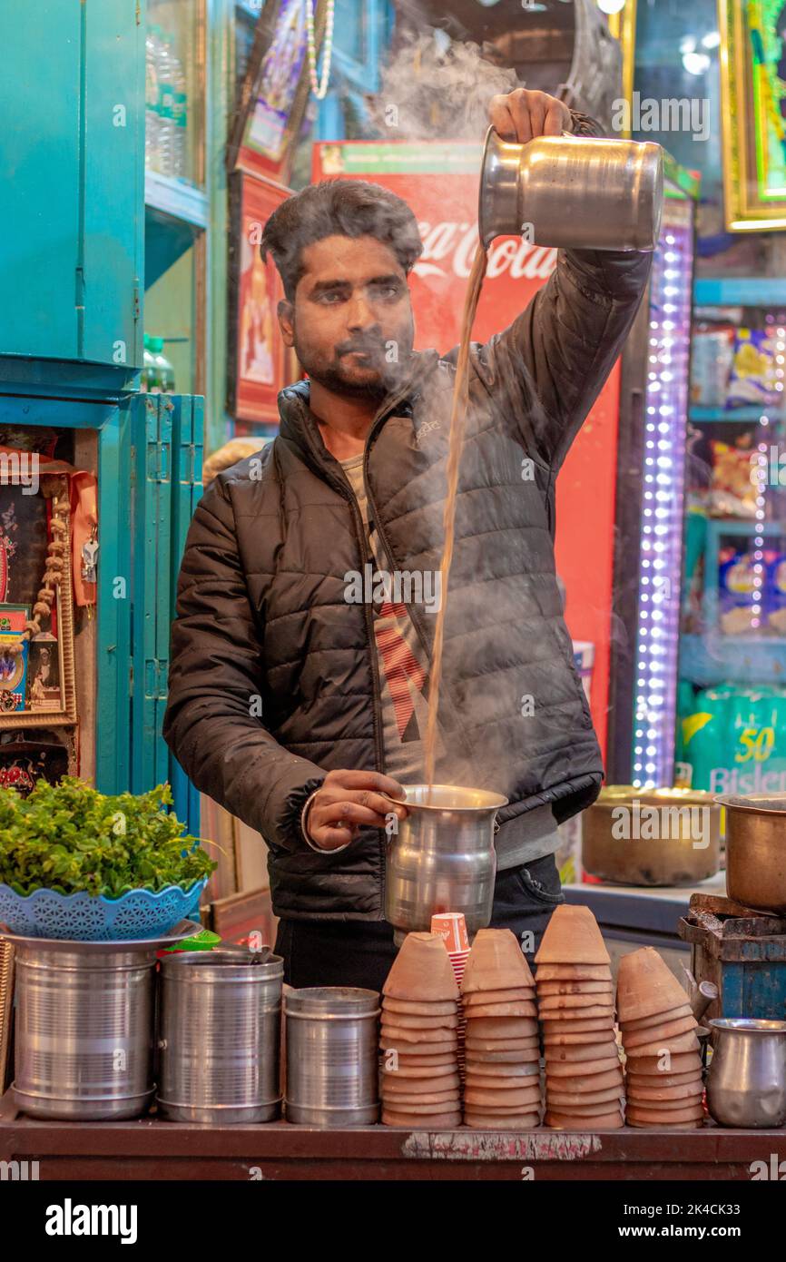 An Indian man cooking food in the street of city market, vertical Stock ...