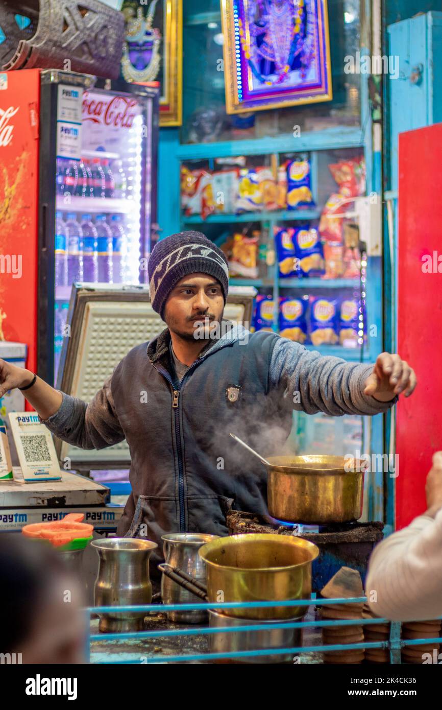An Indian man cooking food in the street of city market, vertical Stock ...