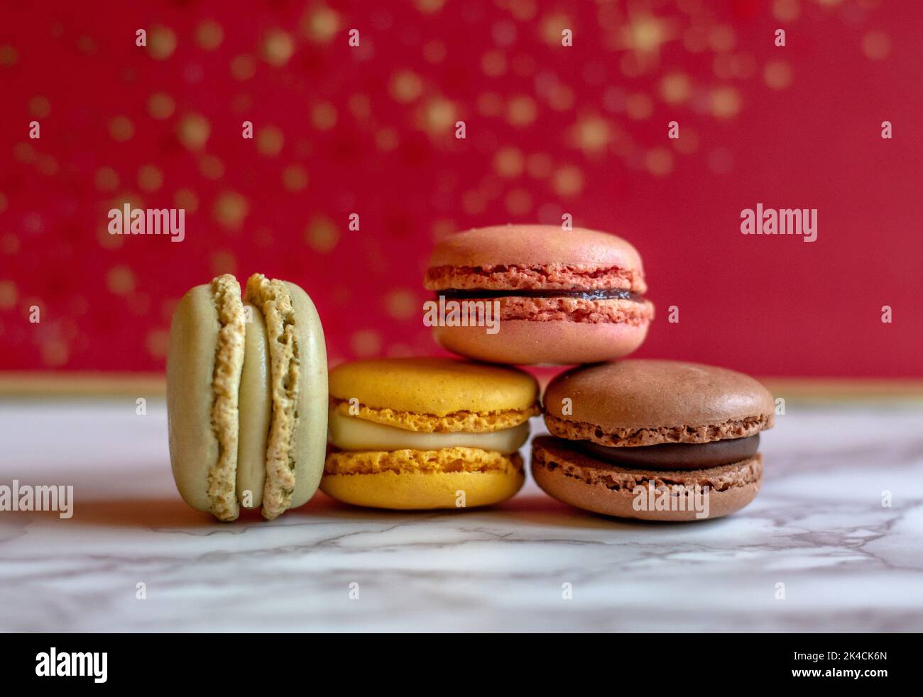 Sweet holiday macaron still life against a red background Stock Photo ...