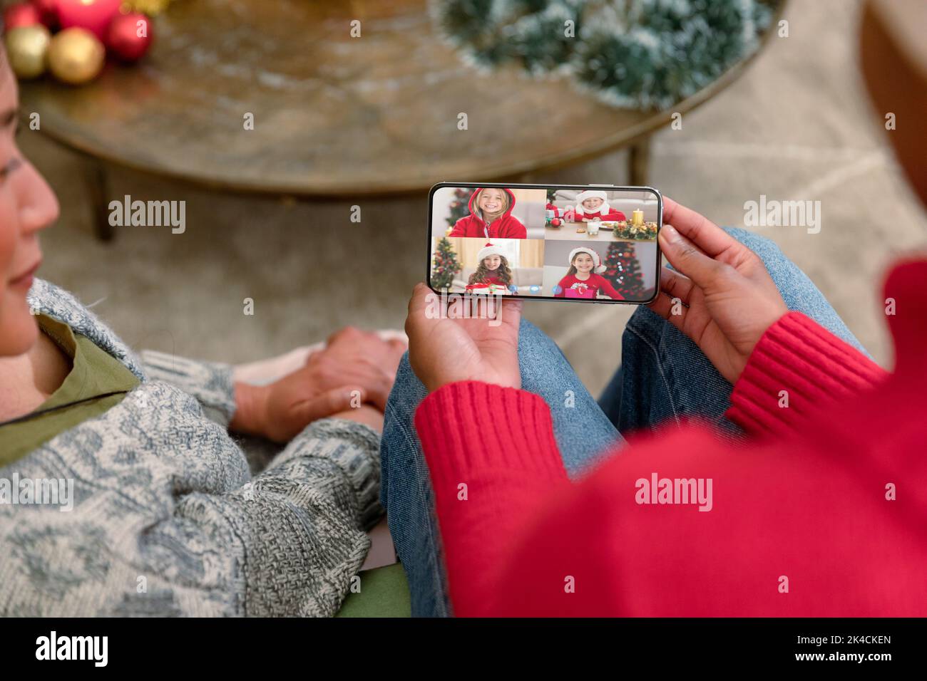 Smiling diverse couple making smartphone christmas video call with ...