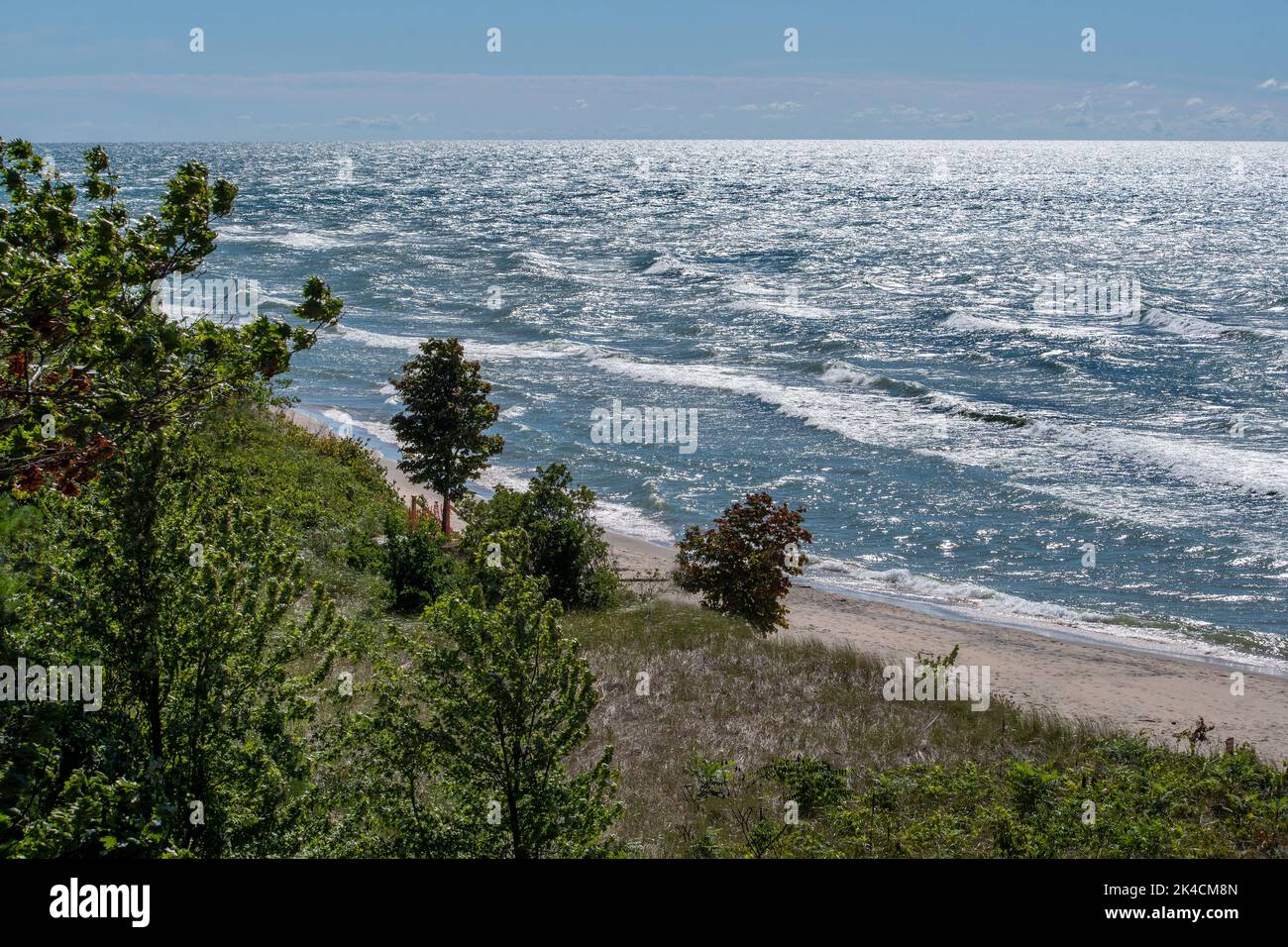 lake Michigan glows silver in the late afternoon light in Michigan USA ...