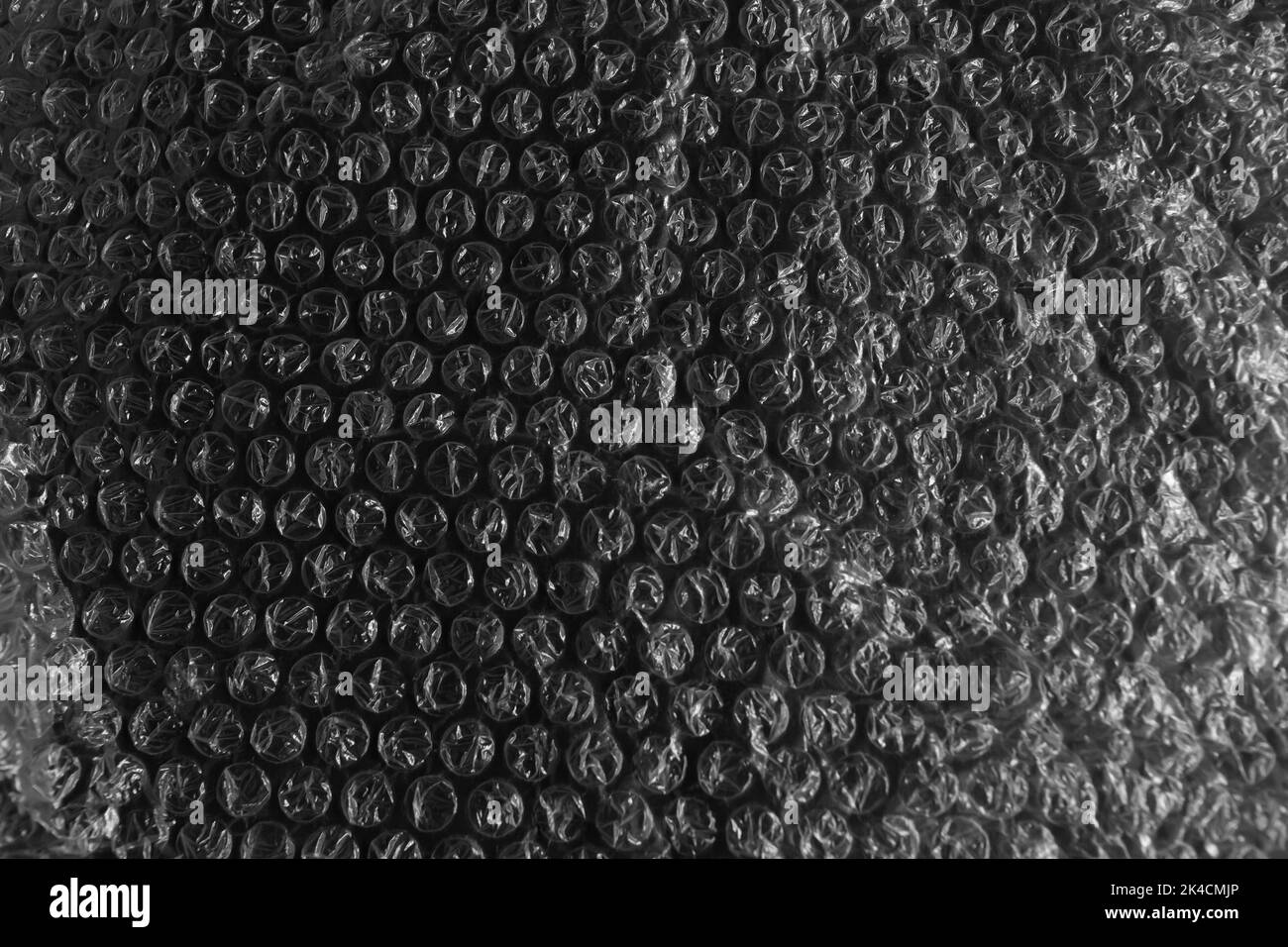 Reflecting light and shadow on creases and folds in plastic bubble wrap ...