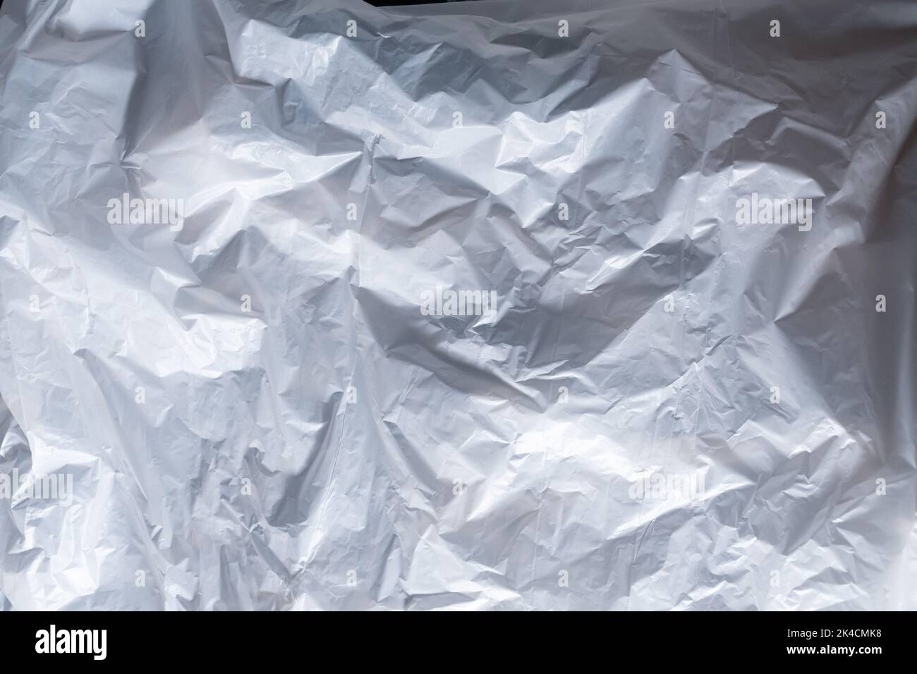 Reflecting light and shadow on creases and folds in scrunched white ...