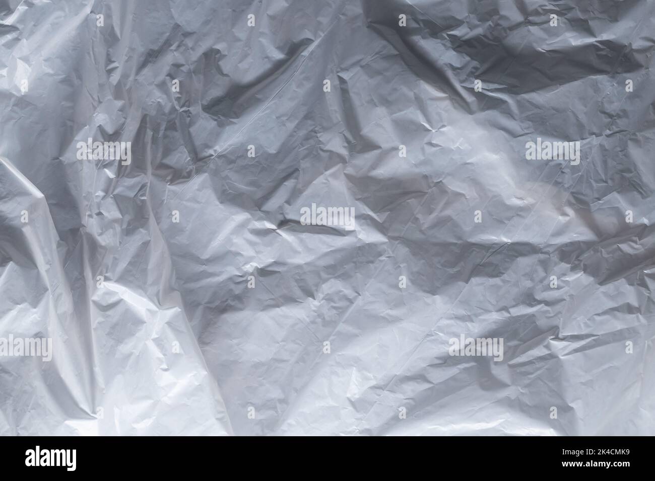 Reflecting light and shadow on creases and folds in scrunched white ...