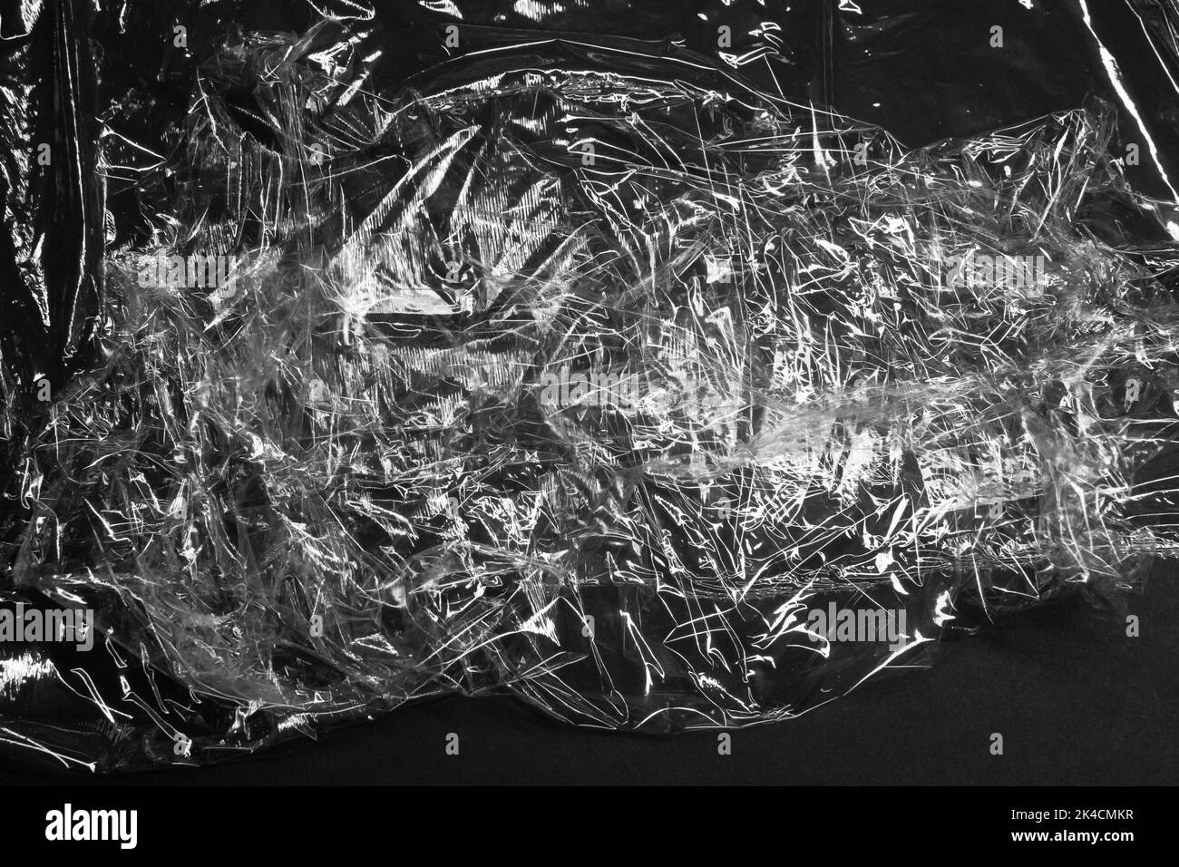 Reflecting light and shadow on creases and folds in scrunched clear ...